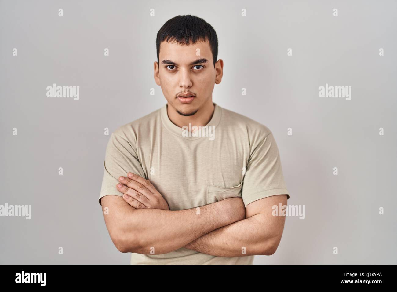 Young arab man wearing casual t shirt skeptic and nervous, disapproving ...