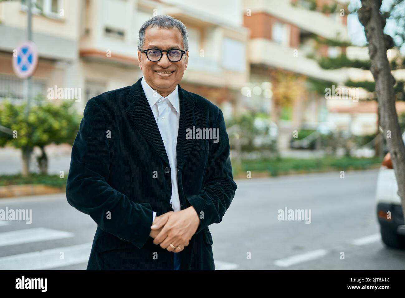 Middle age southeast asian man standing and smiling confident at the ...