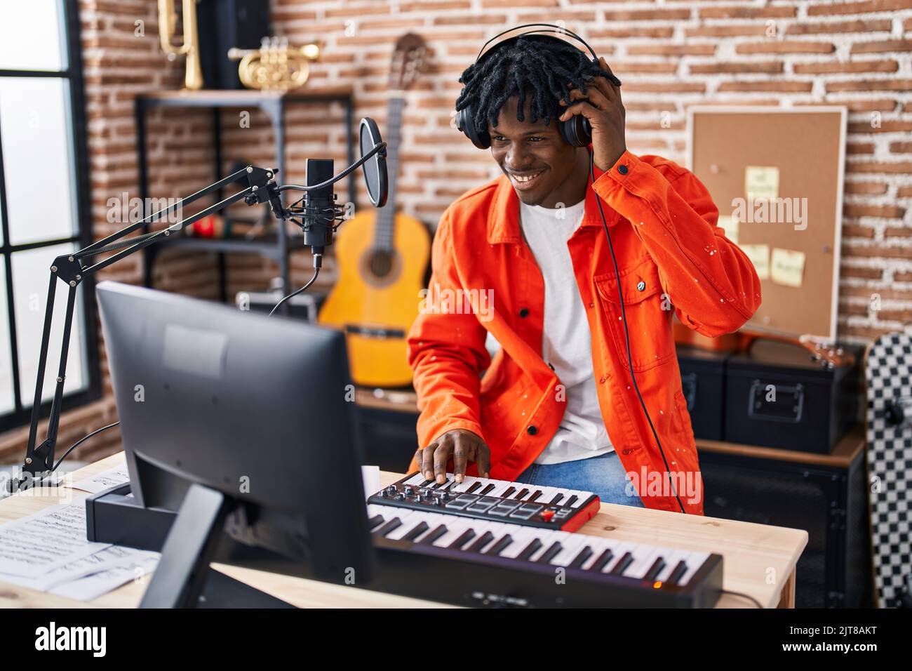 African american man musician playing piano keyboard at music studio ...