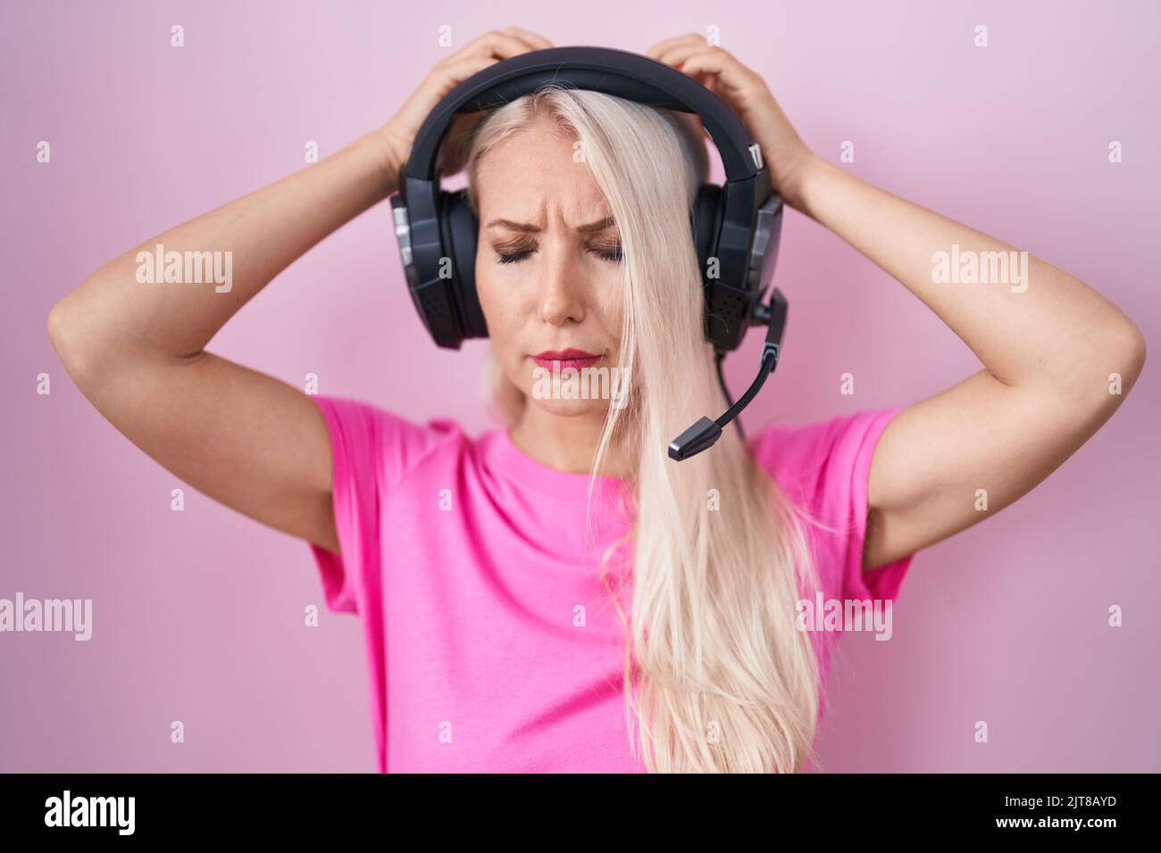 Caucasian woman listening to music using headphones suffering from ...