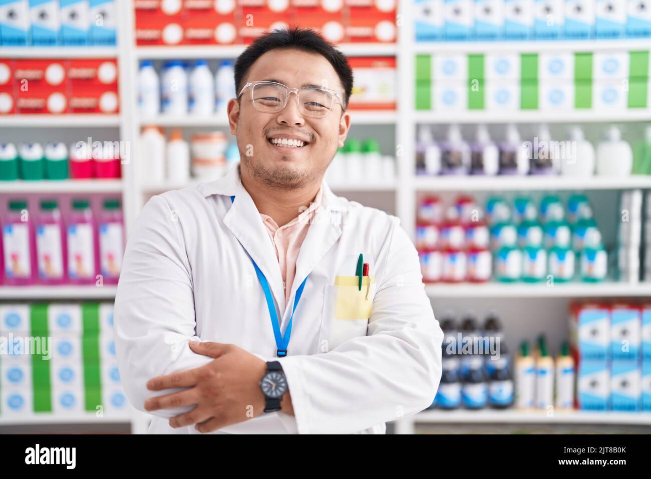 Chinese young man working at pharmacy drugstore happy face smiling with ...