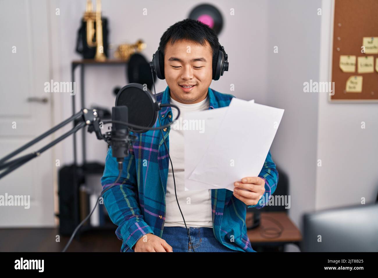 Young chinese man singer singing song at music studio Stock Photo - Alamy