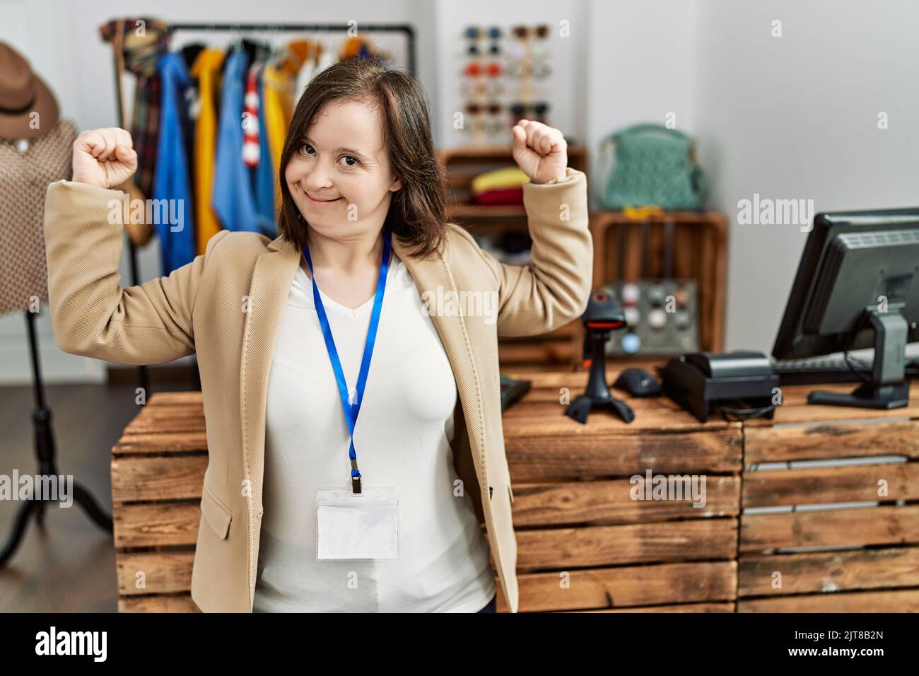 Young down syndrome woman working as manager at retail boutique showing ...
