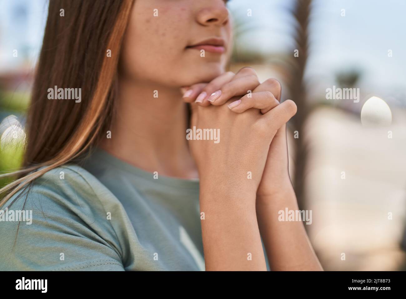 Adorable girl praying at street Stock Photo - Alamy