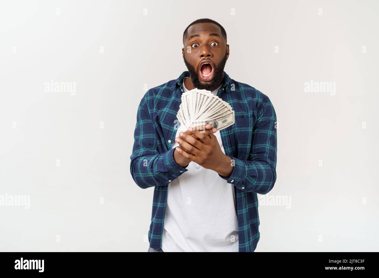 African man holding bank notes happy and surprised cheering expressing ...