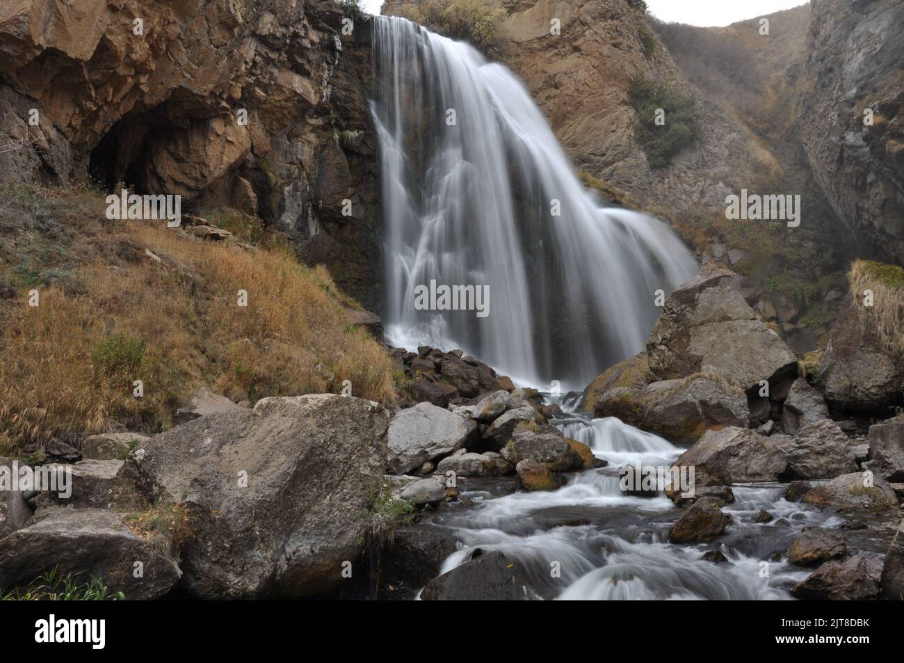 A natural view of the Trchkan waterfall flowing downstream on a rocky ...