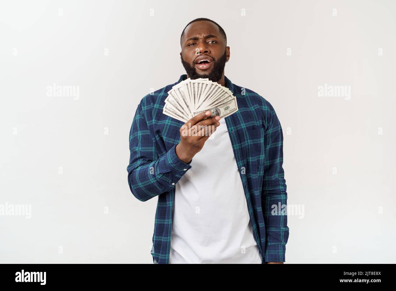 African man holding bank notes happy and surprised cheering expressing ...