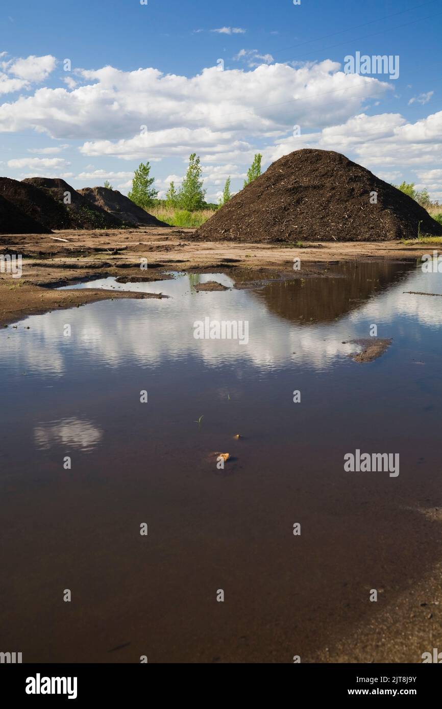 Mounds of dark brown topsoil and tree bark shavings after a heavy ...