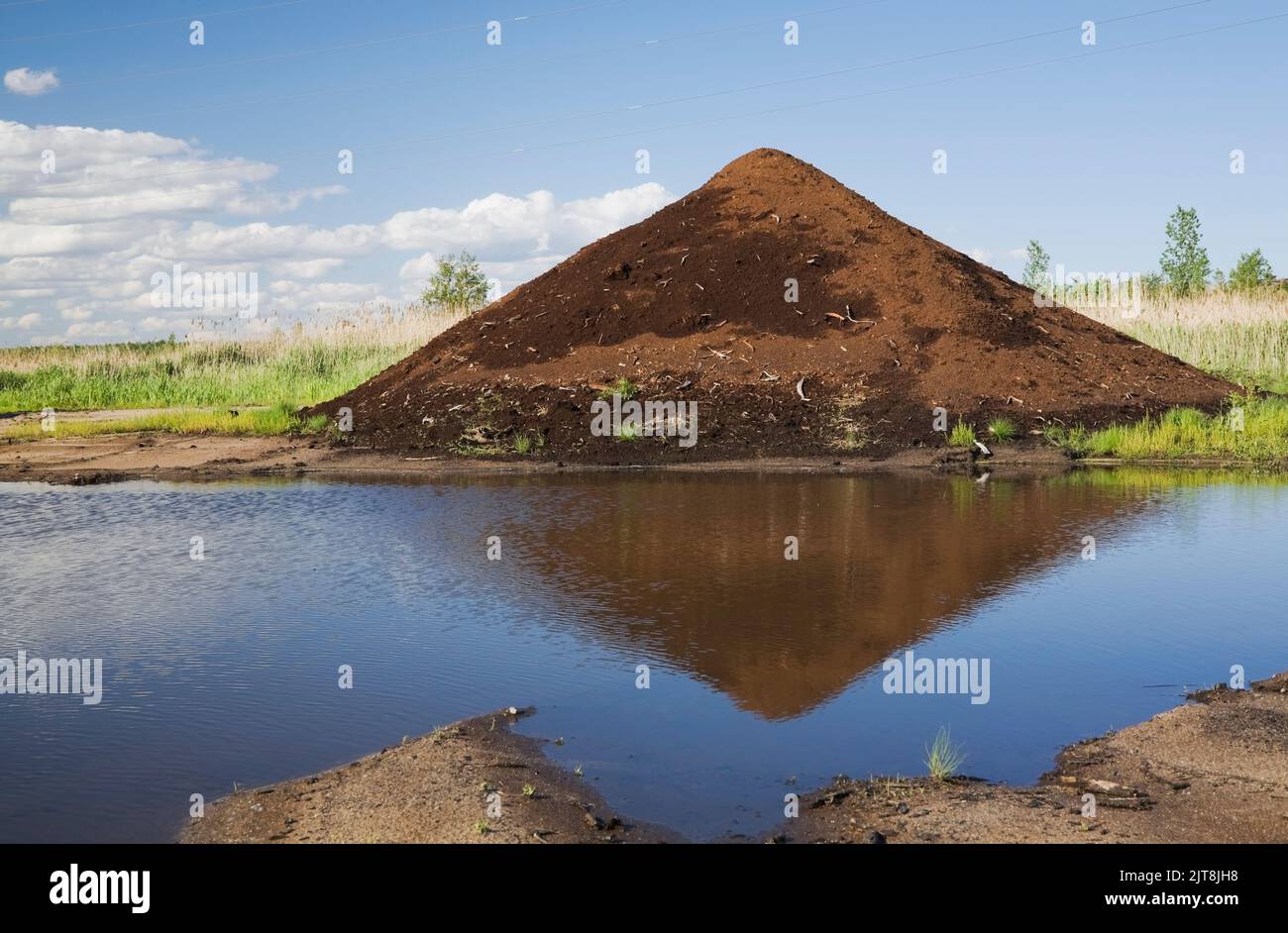 Mound of topsoil after a heavy rainfall in a commercial sandpit Stock ...