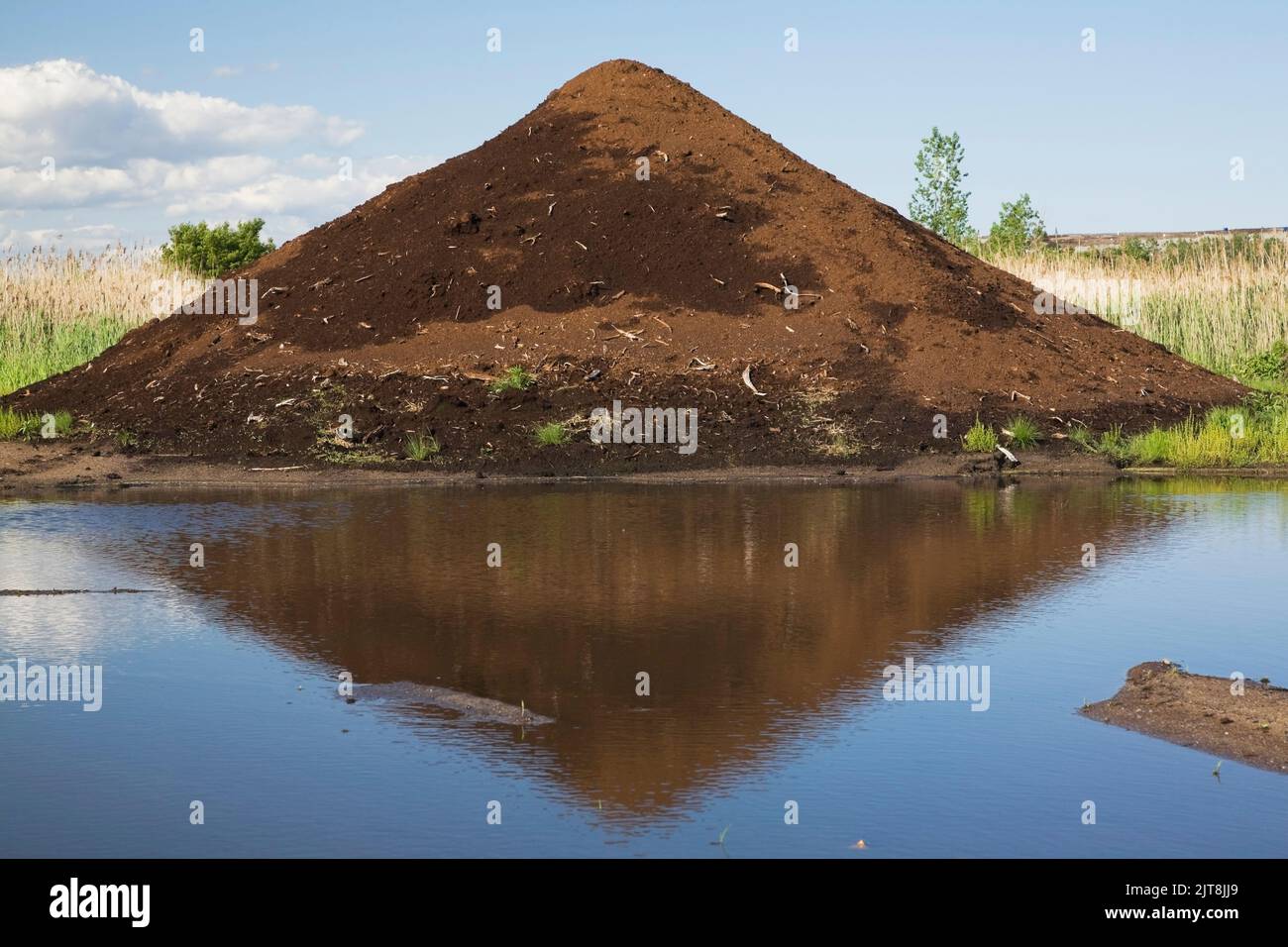 Mound of topsoil after a heavy rainfall in a commercial sandpit Stock ...