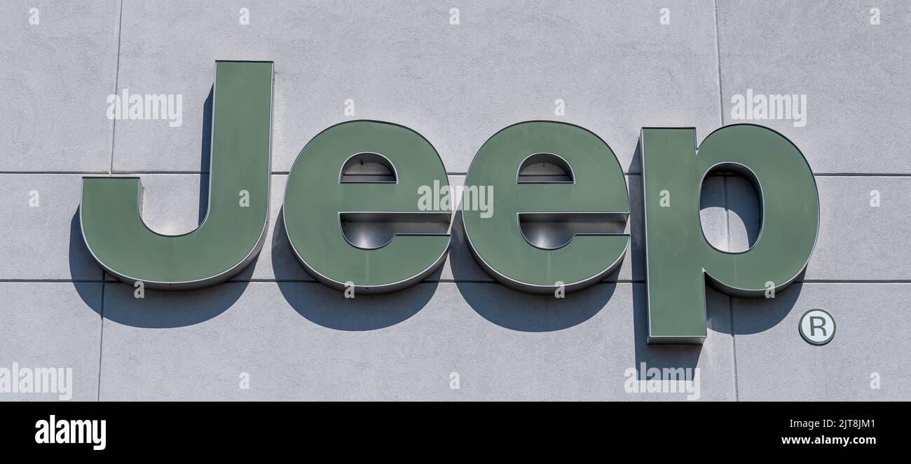 A green Jeep sign for the automobile on a concrete wall Stock Photo - Alamy