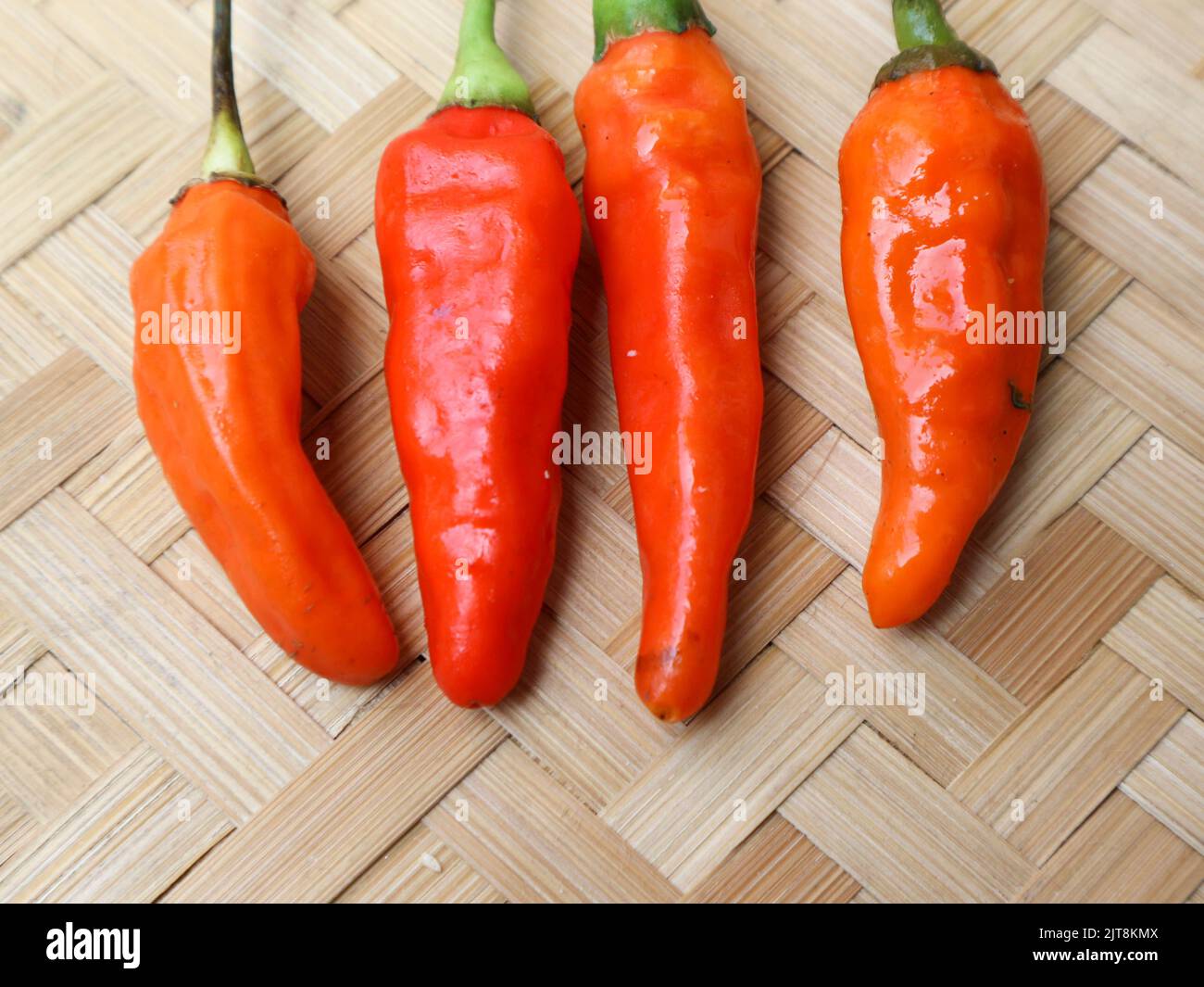 spicy red cayenne pepper, on a woven bamboo background Stock Photo - Alamy