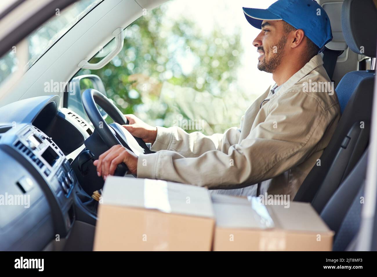 En route with your delivery. a handsome young man making deliveries in ...