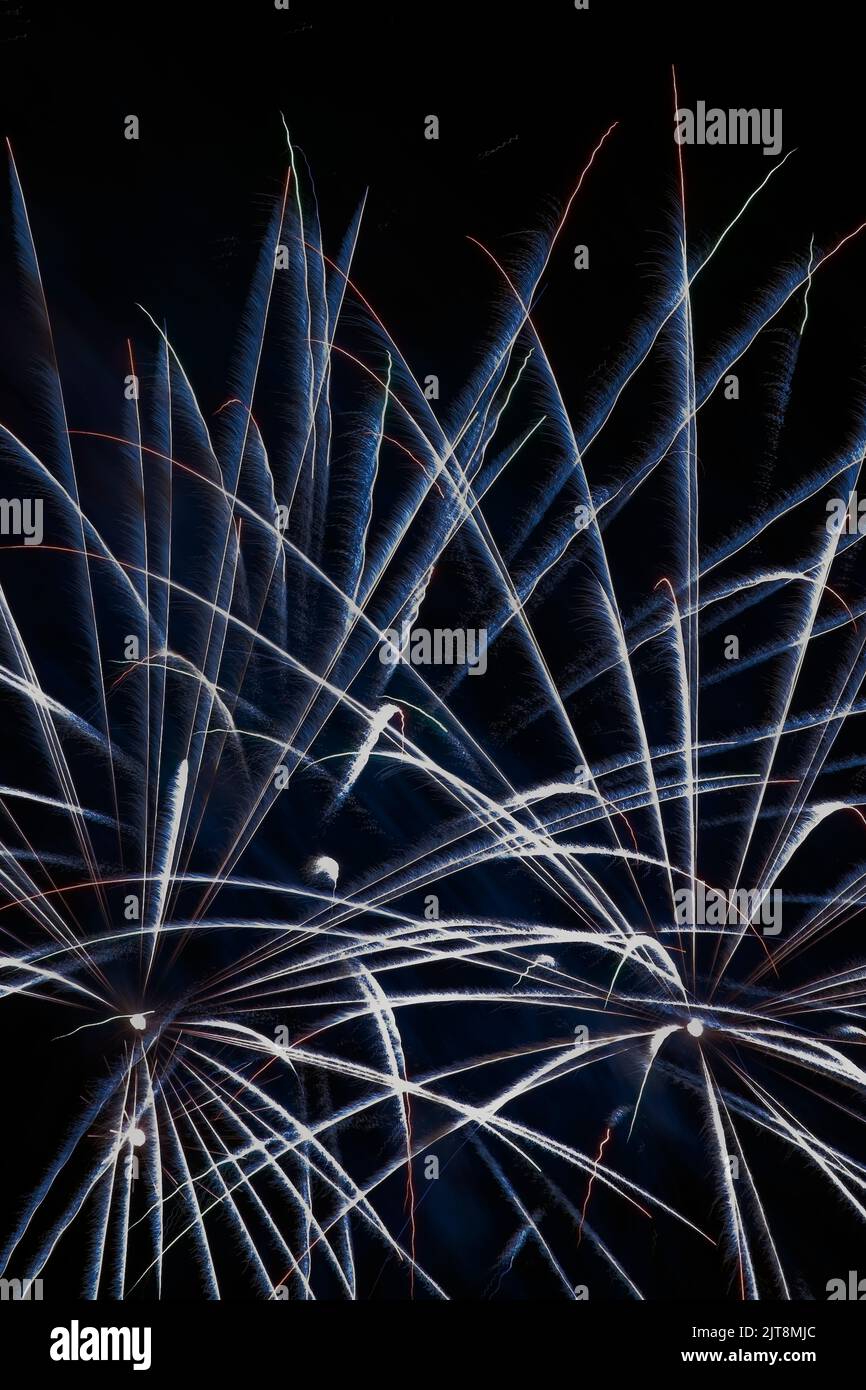 White and blue fireworks in the night sky Stock Photo - Alamy
