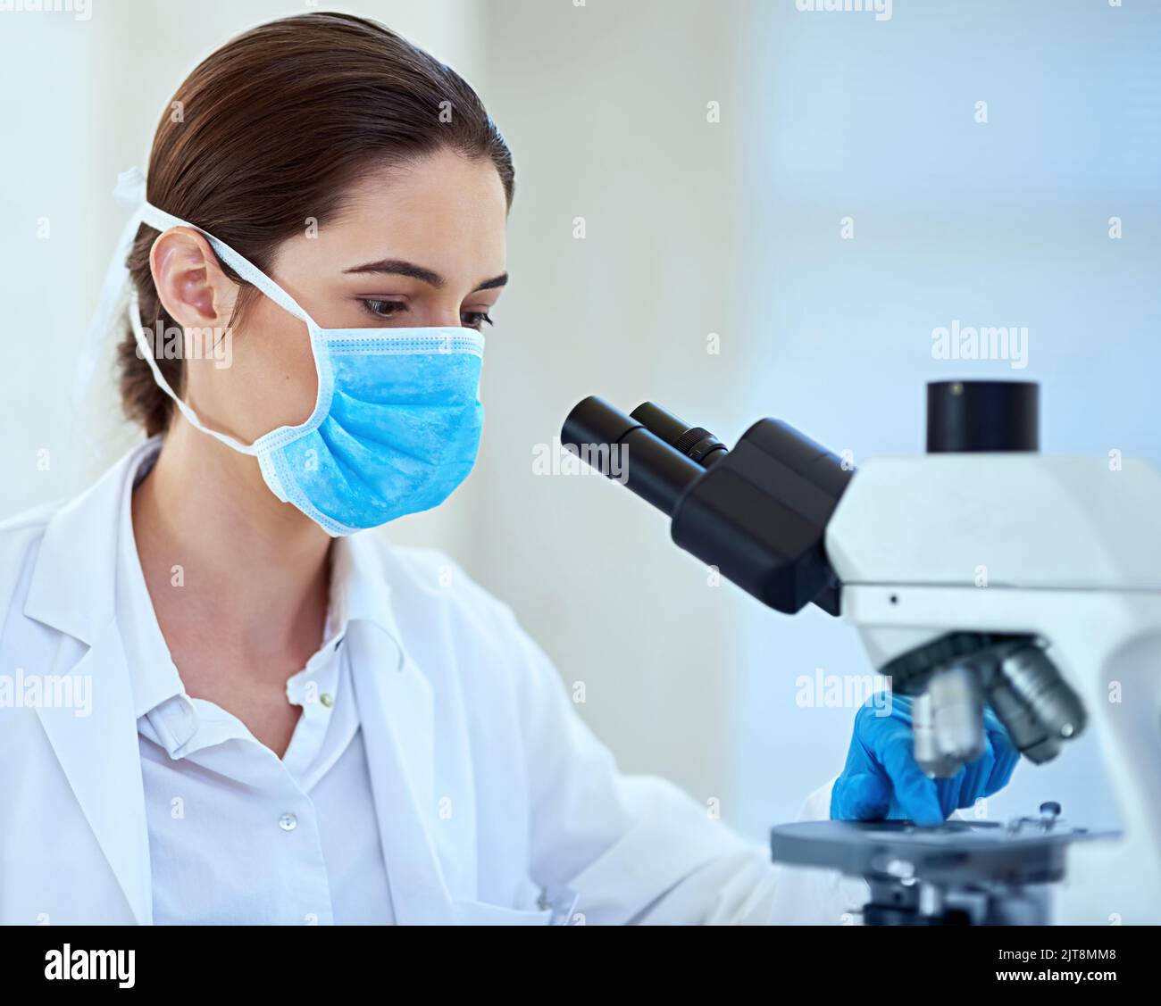 Even the small details are vital in science. a female scientist working ...