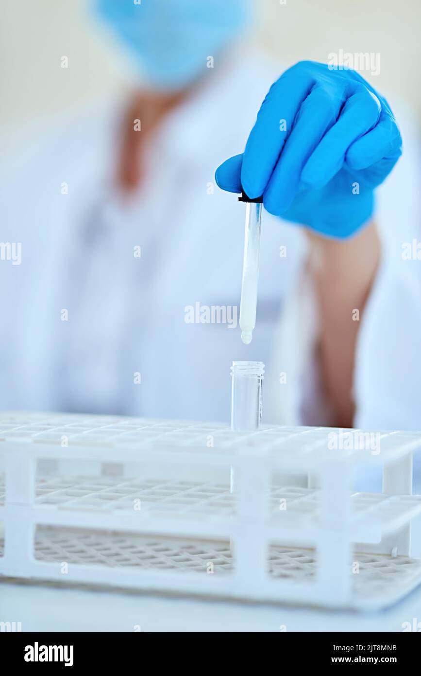 The answers are all in the details. a female scientist working alone in ...