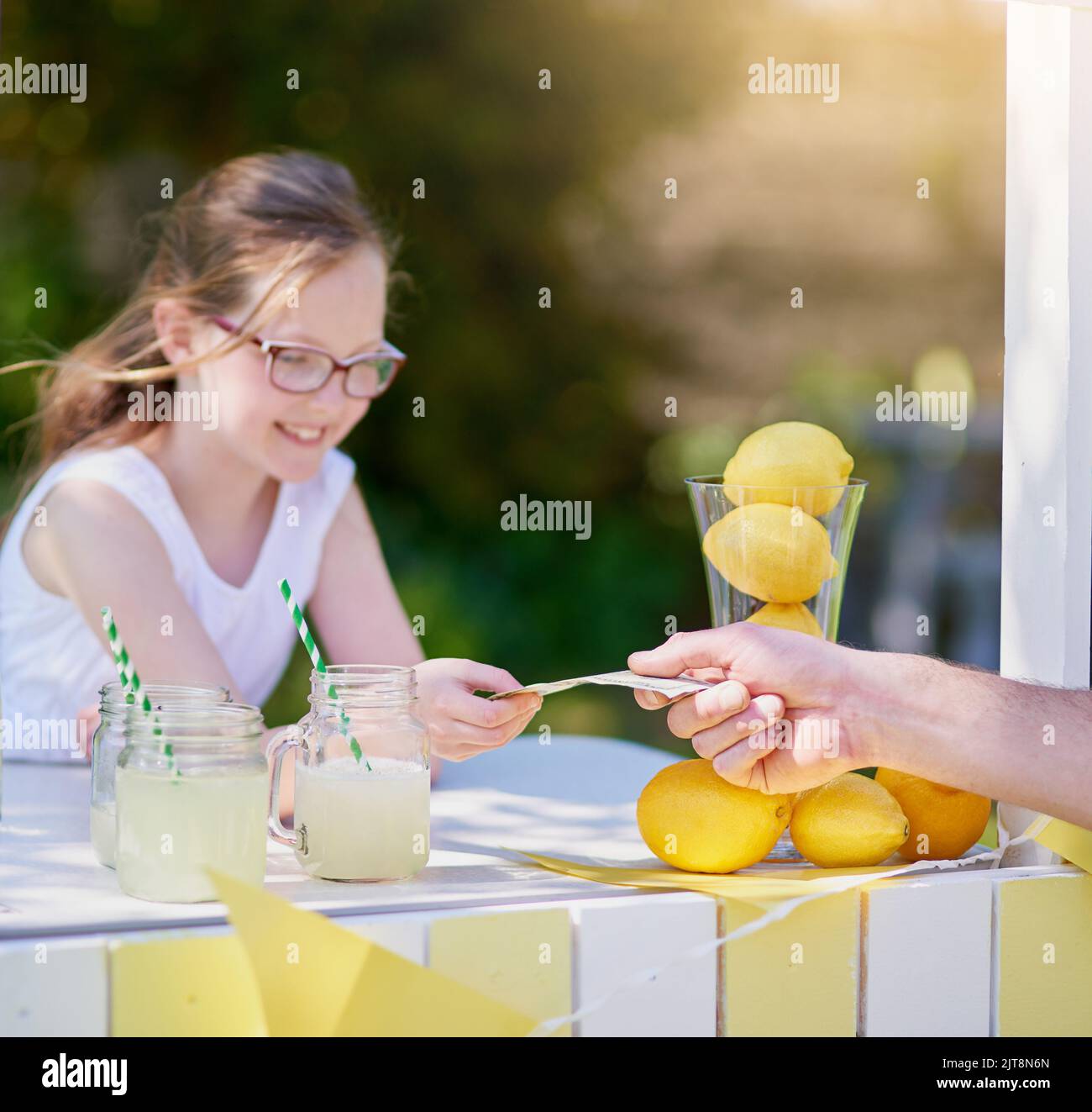 Her drinks are selling out fast. a little girl selling lemonade from ...