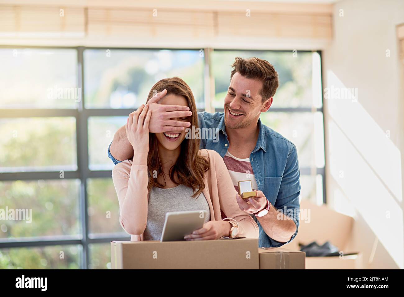 No peeking. a young man surprising his girlfriend by proposing while ...