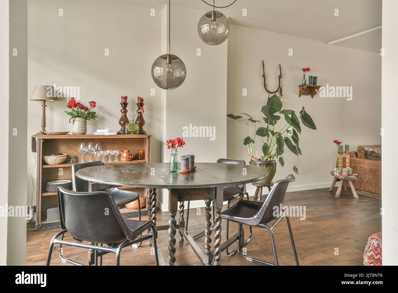 Couches and table located near TV against dining area of spacious room ...