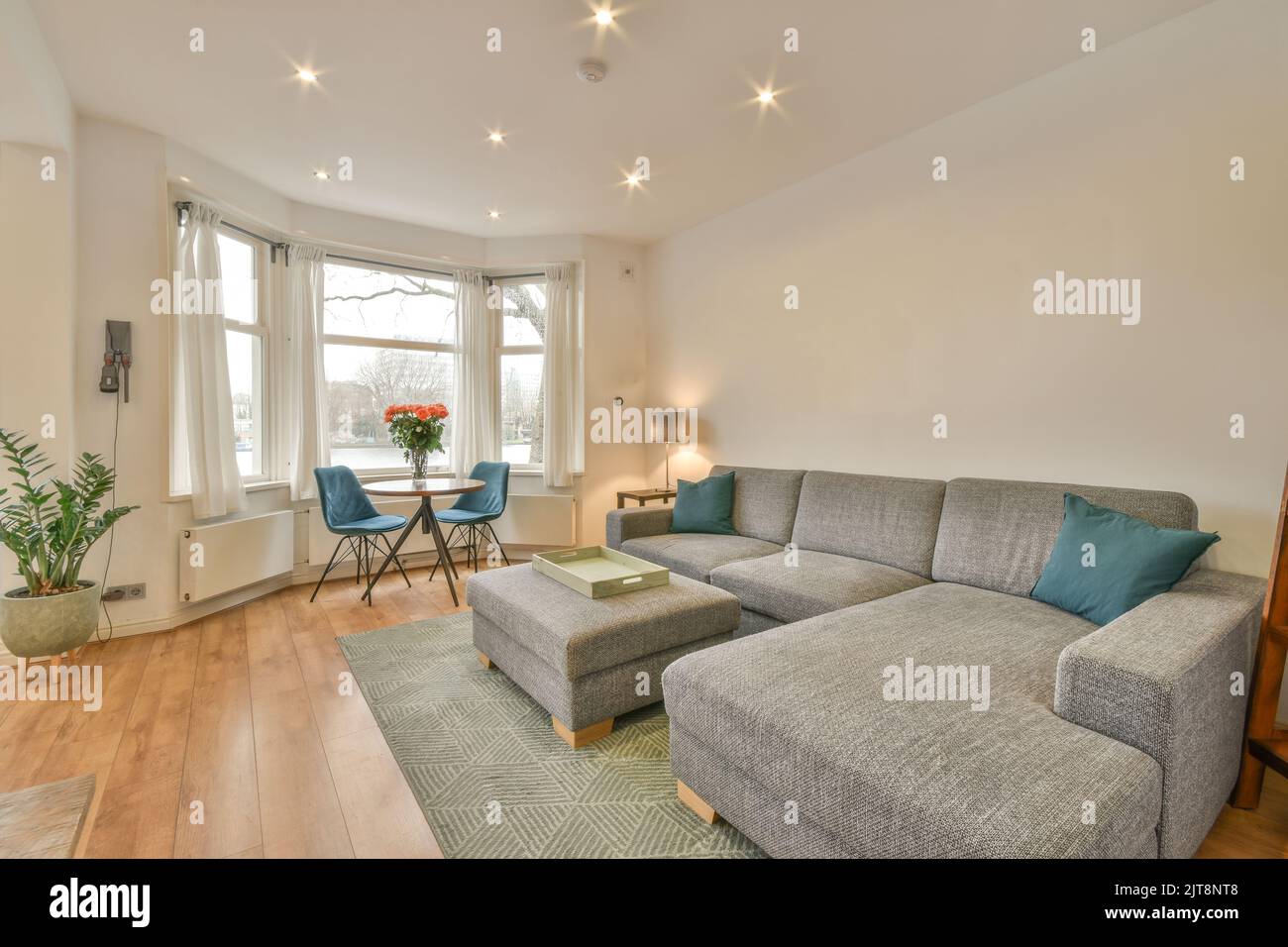 Interior of modern room illuminated with sunlight from ceiling window ...
