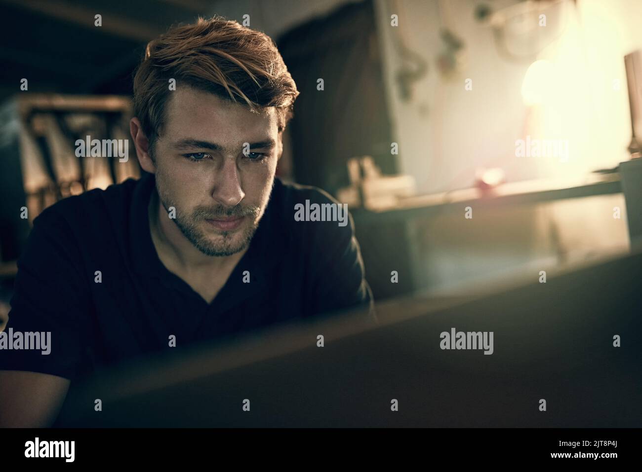 We make sacrifices for success. a handsome young man working late in ...