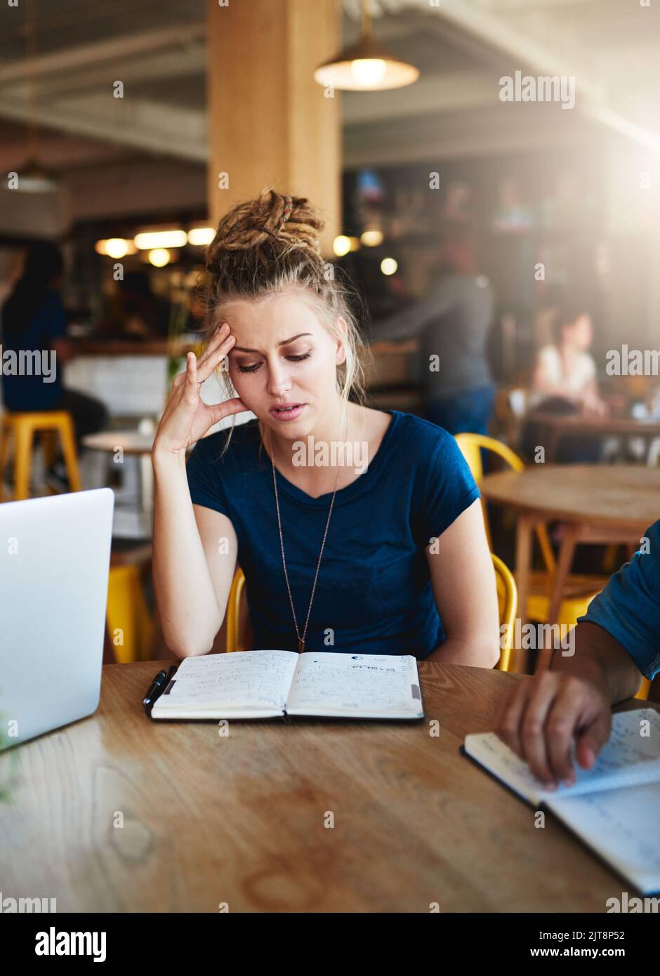 The price of success is hard work. a young student looking stressed ...