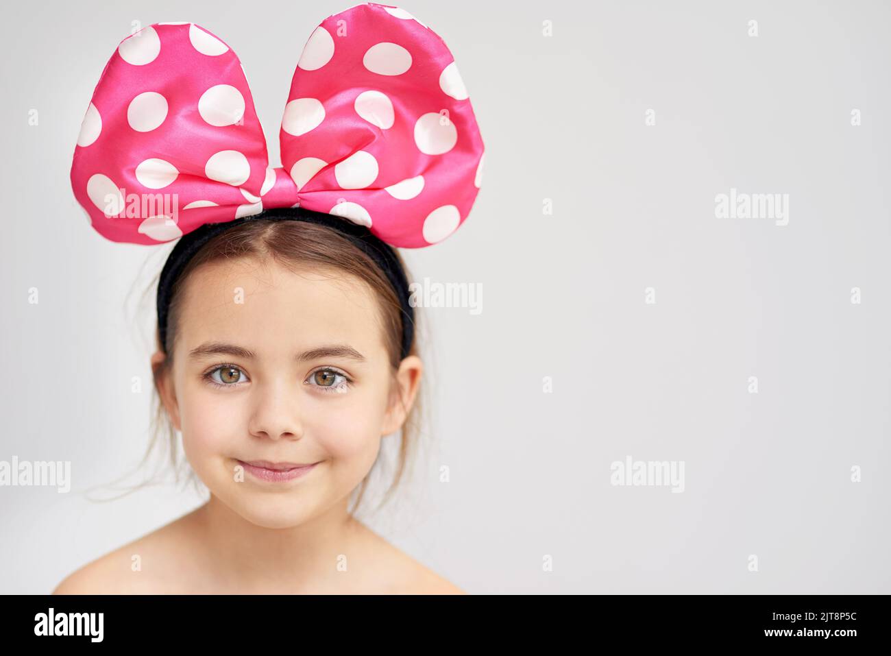 Feeling dotty. Studio portrait of a cute little girl wearing an alice ...