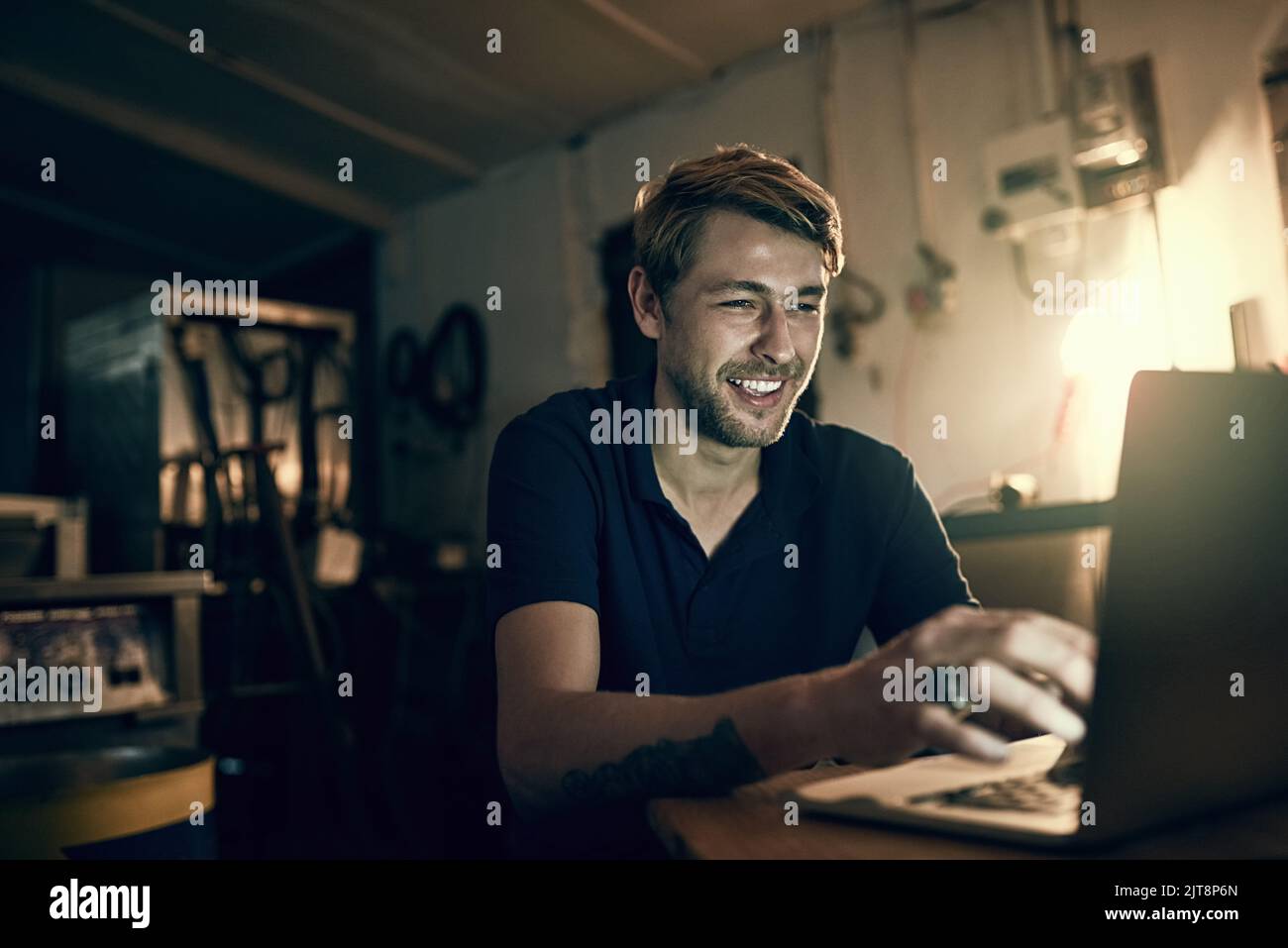 He doesnt mind burning the midnight oil. a handsome young man working ...