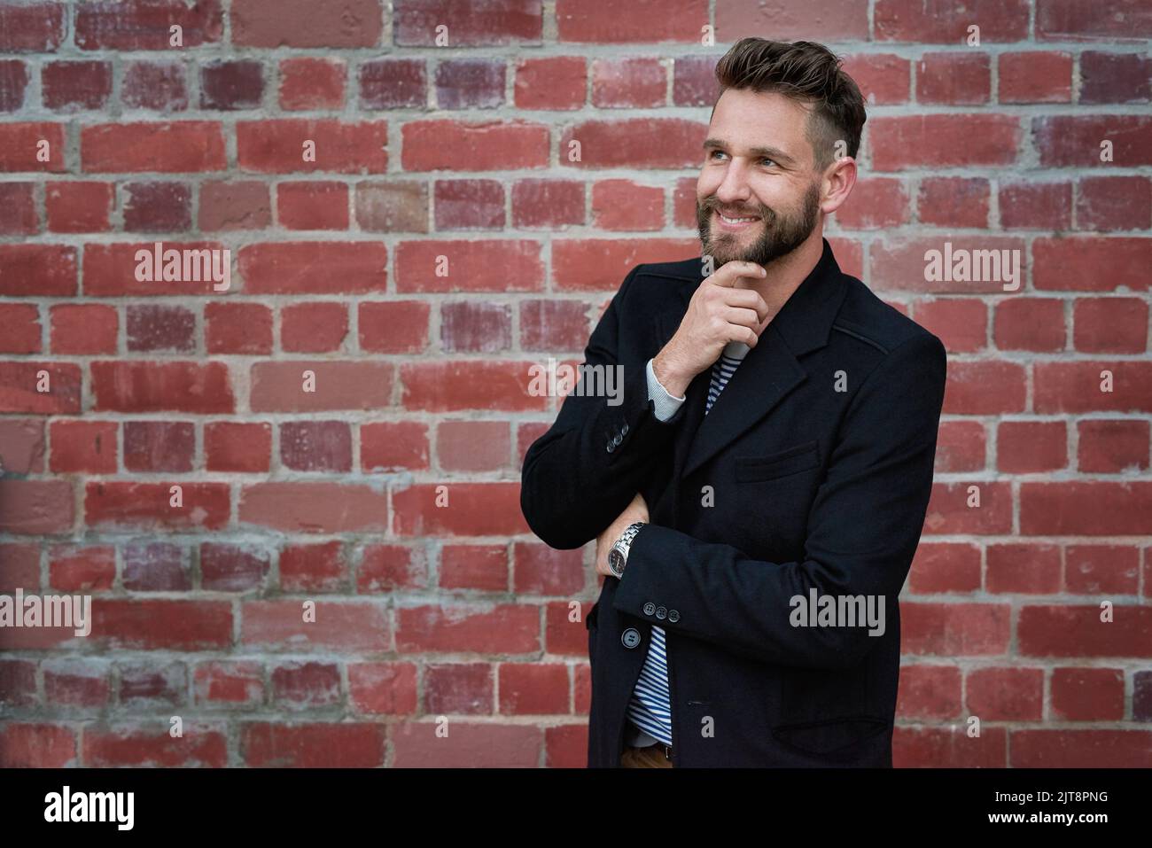 Caught in some deep reflection. a handsome young man looking thoughtful ...