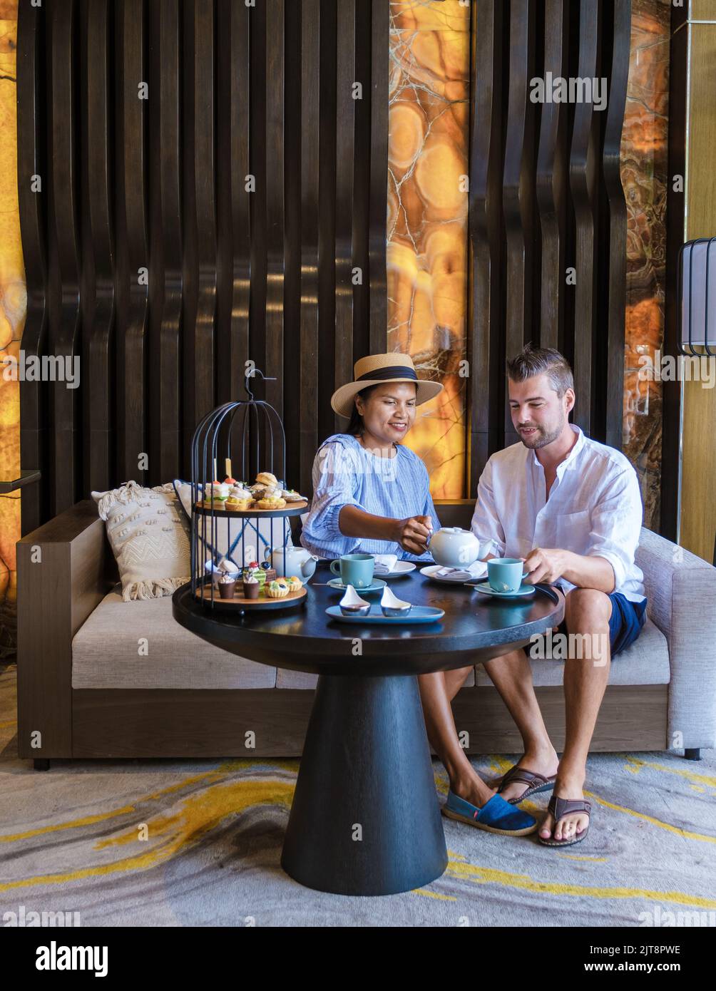 Caucasian men and Asian women having a Luxury high tea with snacks and ...