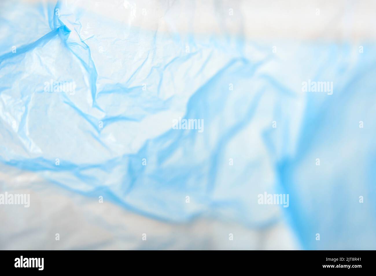 White and blue plastic background, wrinkled single use bag. Concepts ...