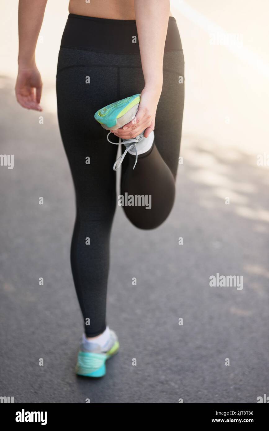 Warming up for her workout. Rearview shot of an unrecognizable young ...