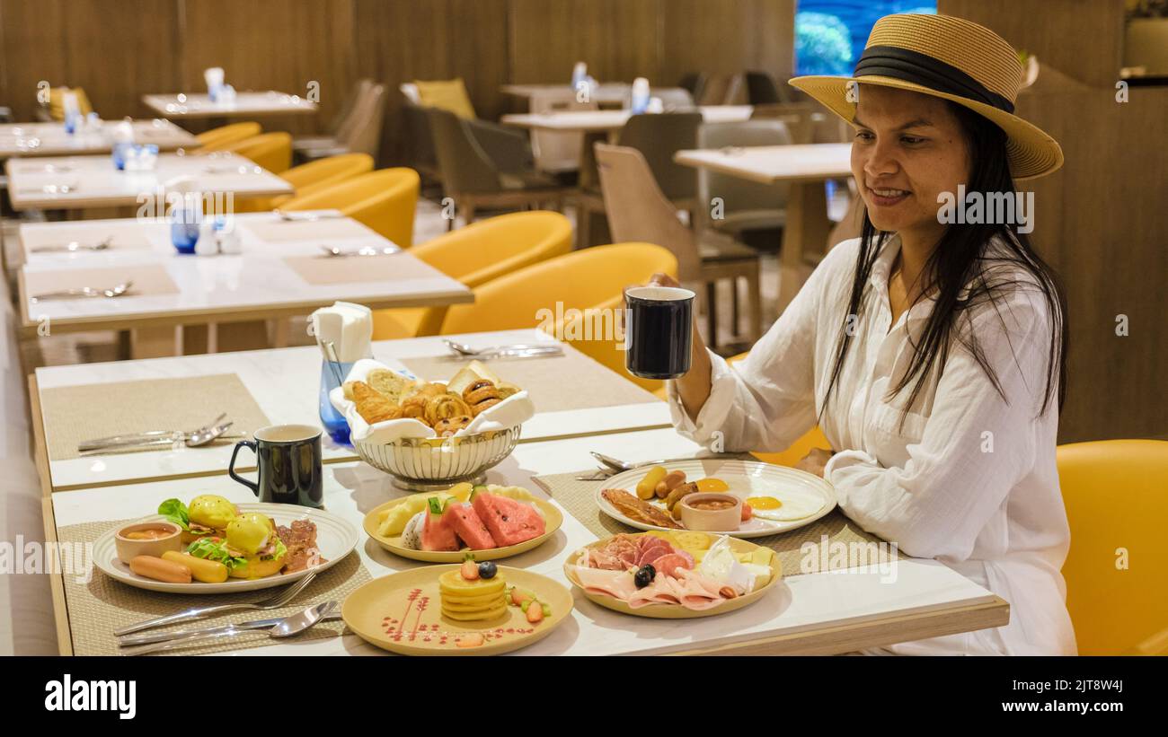 Asian women having a Breakfast buffet in a luxury hotel Stock Photo - Alamy