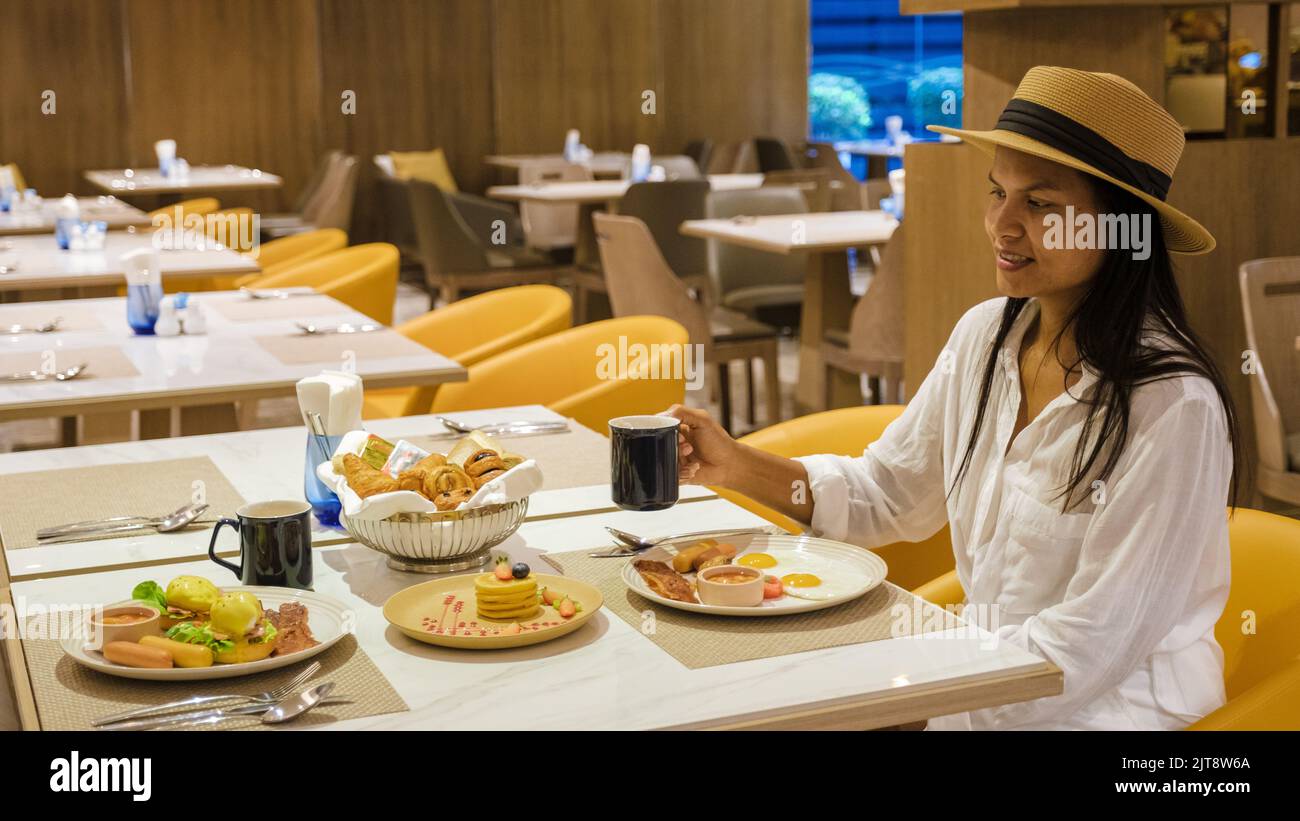 Asian women having a Breakfast buffet in a luxury hotel Stock Photo - Alamy