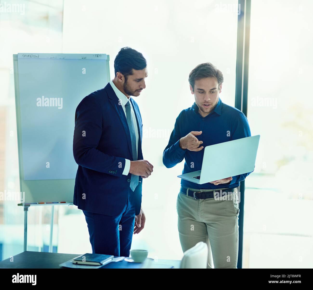 Businessman standing with laptop hi-res stock photography and images ...