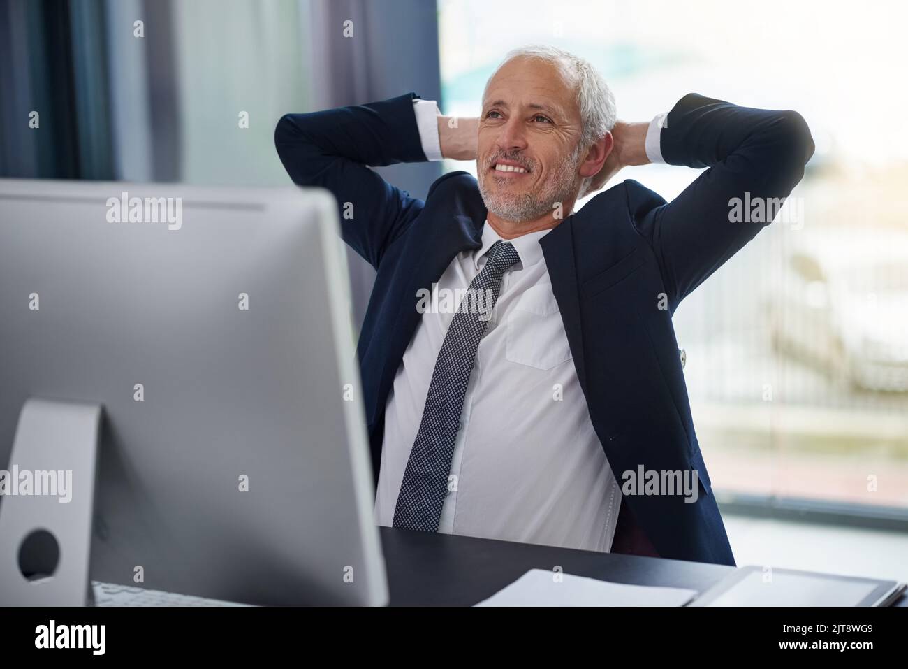 Another successful day in the office. a content mature businessman ...