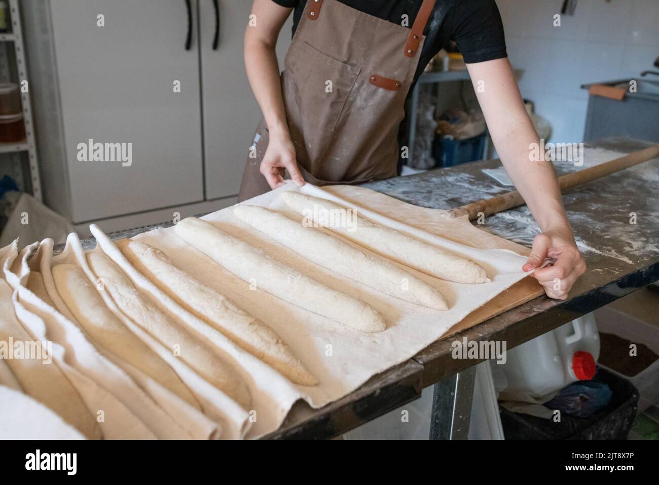 The process of making traditional French baguettes in a craft bakery ...