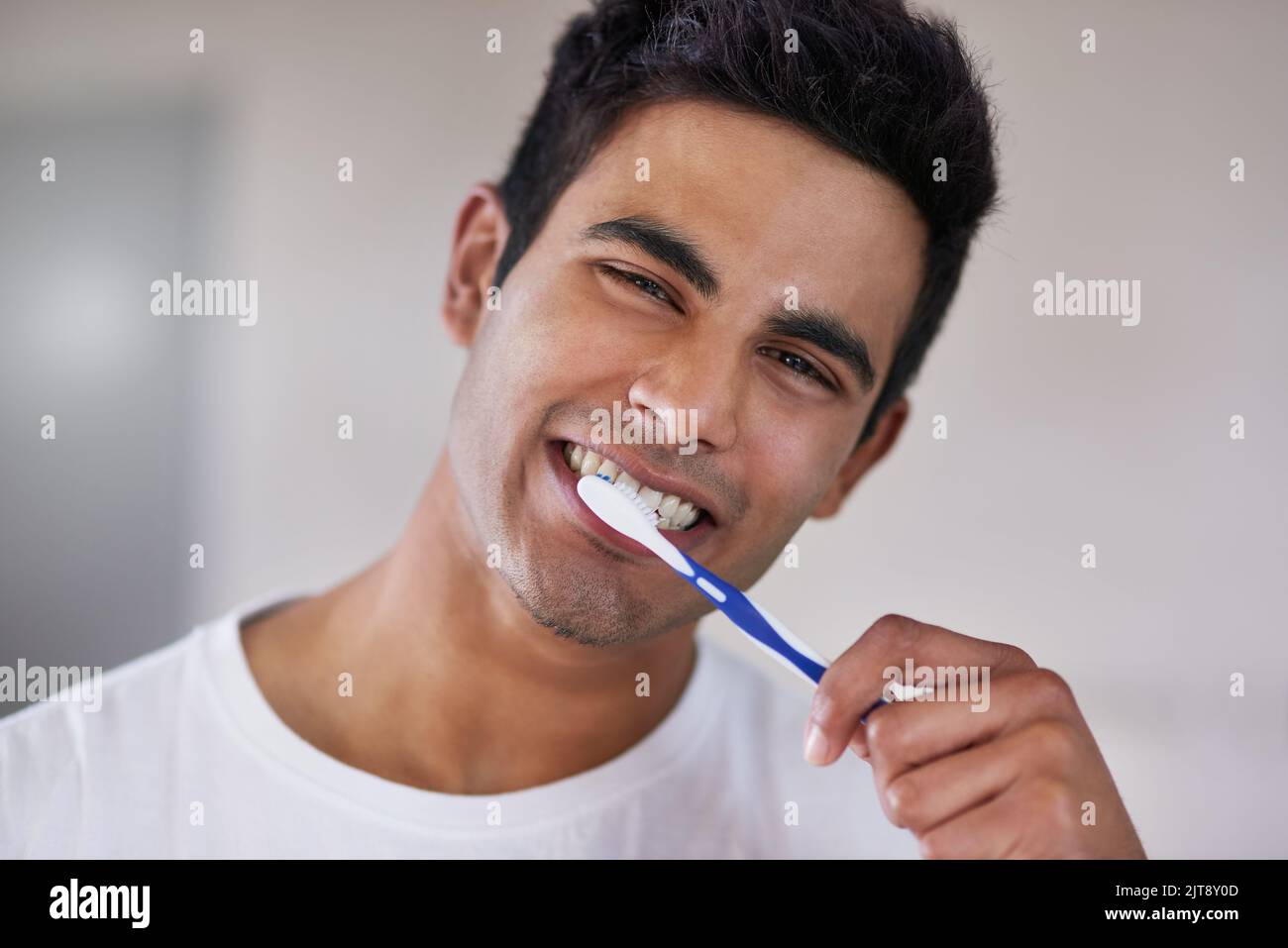 The best defense against dental disease. Portrait of a happy young man ...