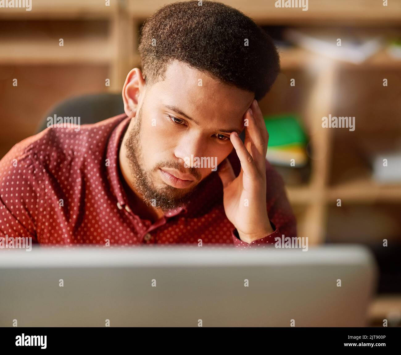 Feeling the pressure of looming deadlines. an stressed out young man ...