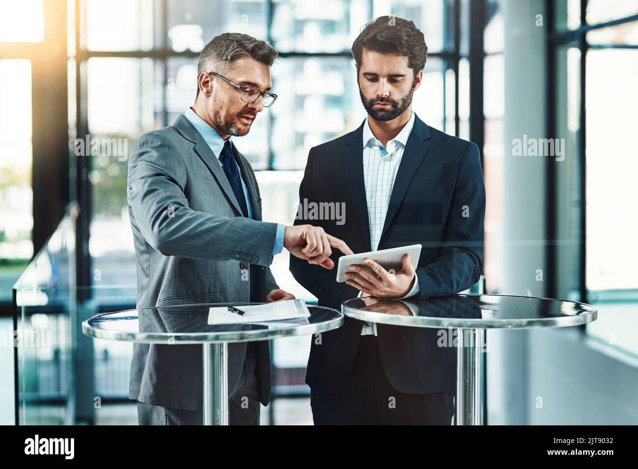 Only the latest tech is used in their company. two colleagues using a ...