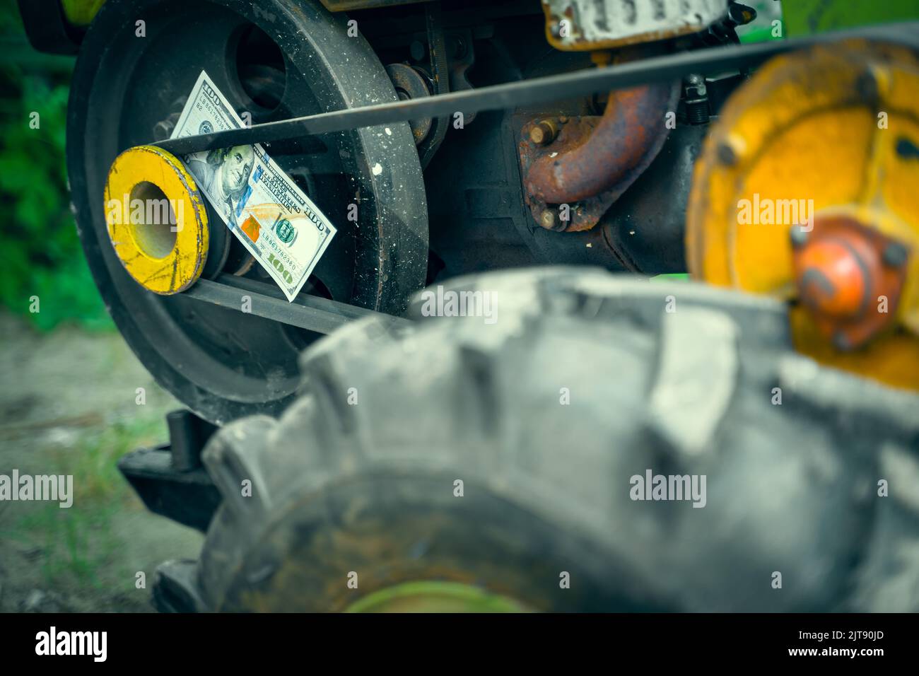 One hundred dollar bill close-up against the background of the engine ...
