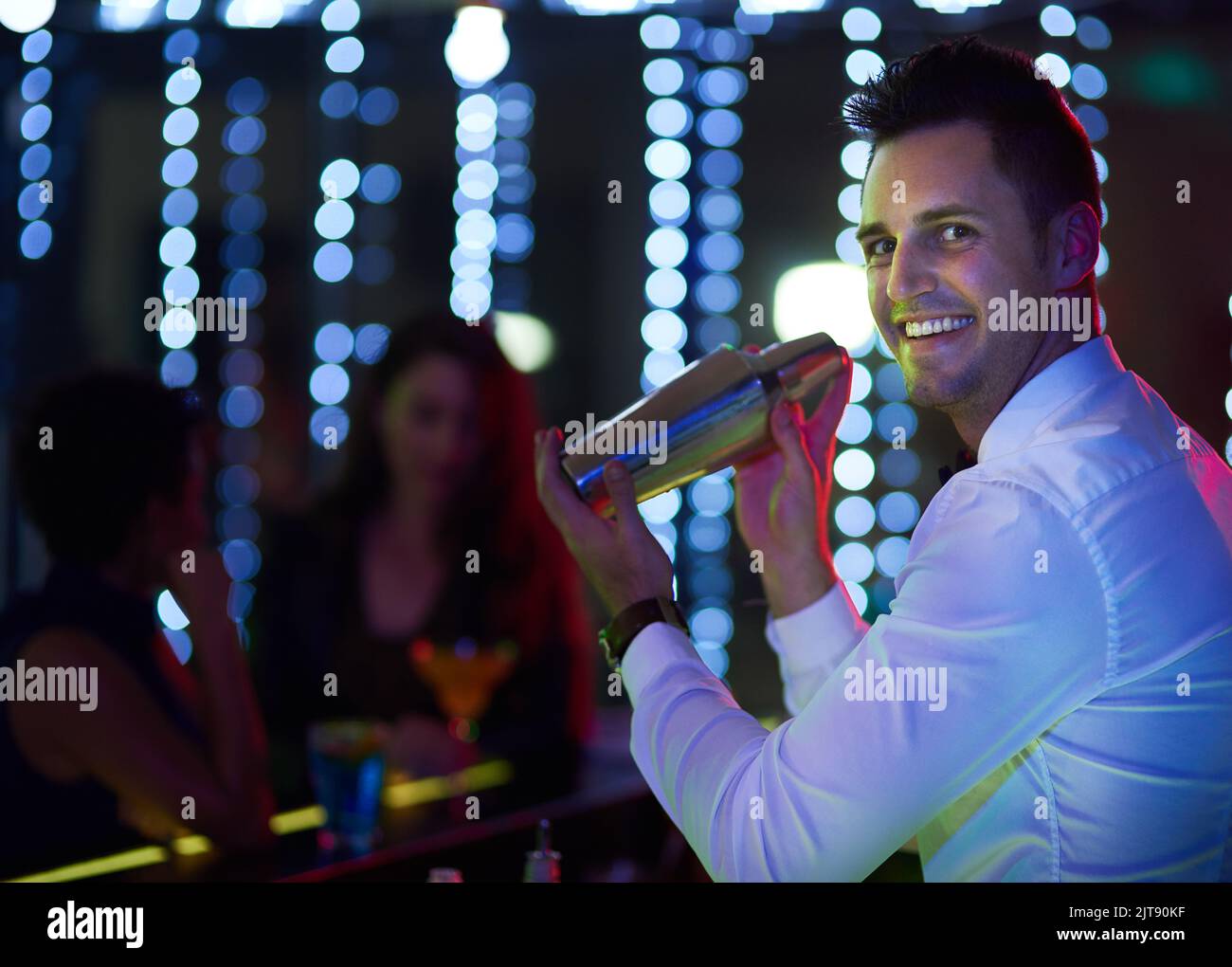 Im a master of mixology. Portrait of a smiling bartender mixing a drink ...