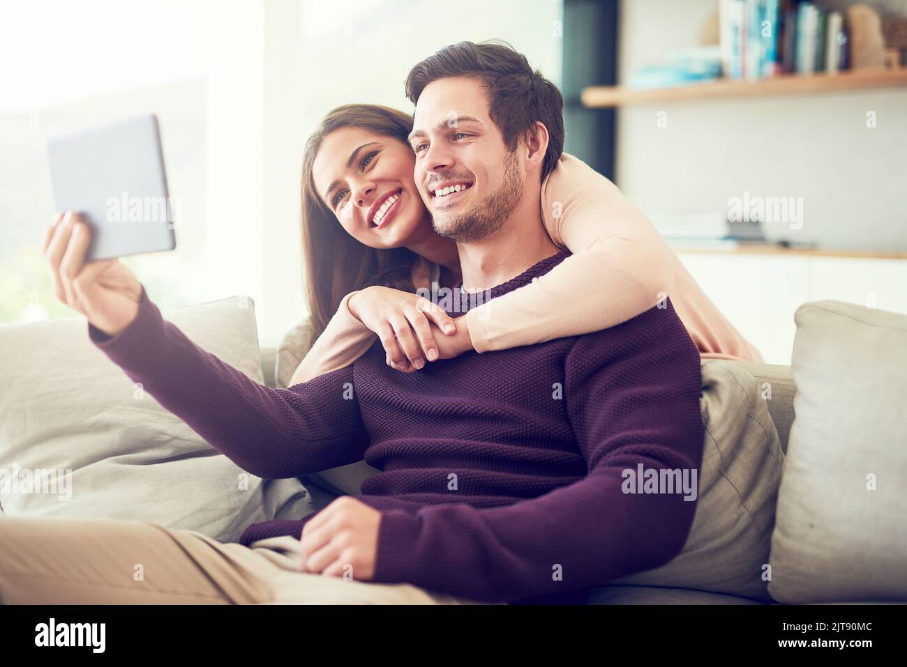 Catching up with some old friends online. a smiling young couple using ...