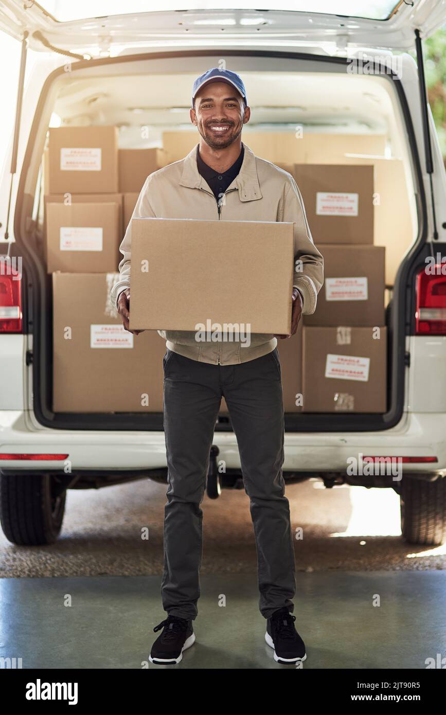 Delivered on time every time. Portrait of a delivery man unloading ...