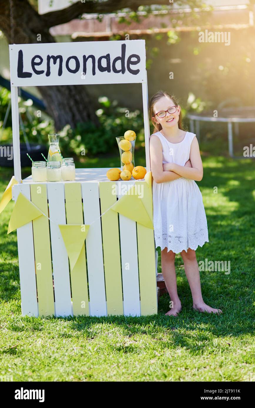 Ready for business. Portrait of a little girl selling lemonade from her ...