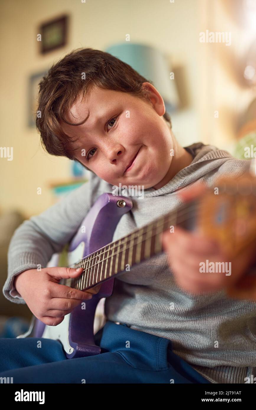 Hes a talented young musician. Portrait of a little boy playing an ...