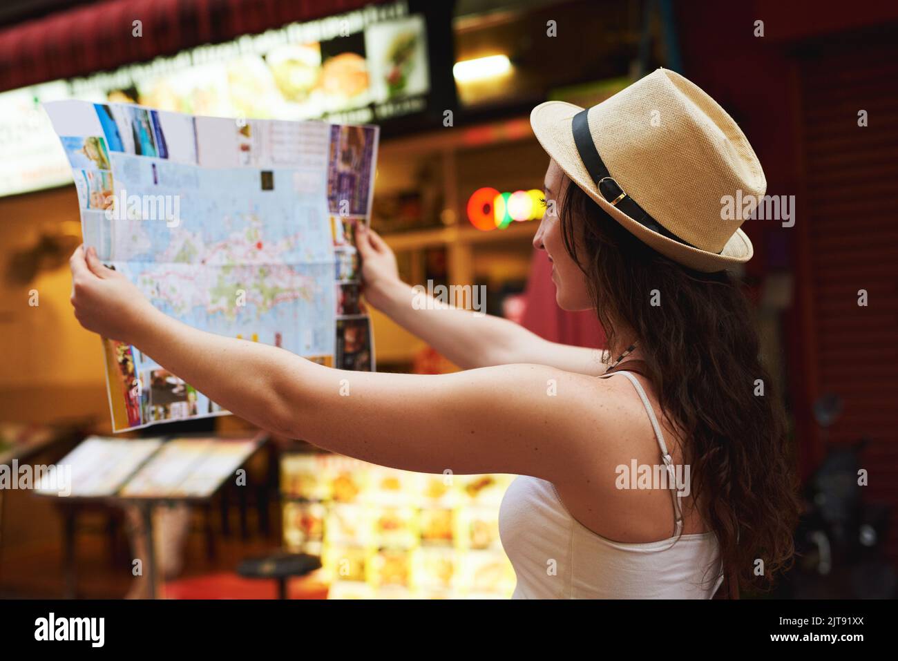 Shes got a whole big city to explore. a young woman using a map while ...