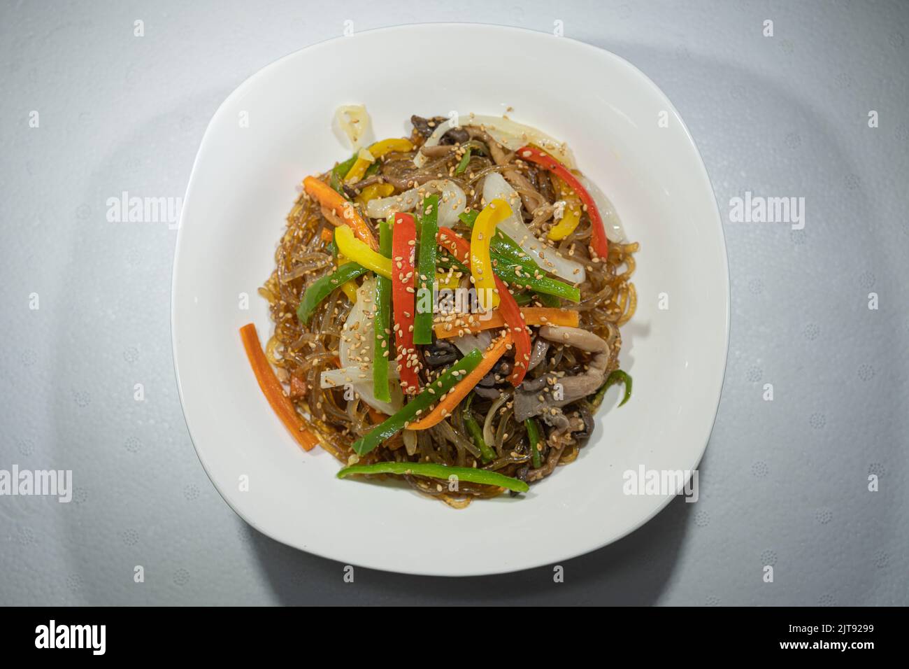 Japchae, a traditional Korean food served in a bowl Stock Photo - Alamy