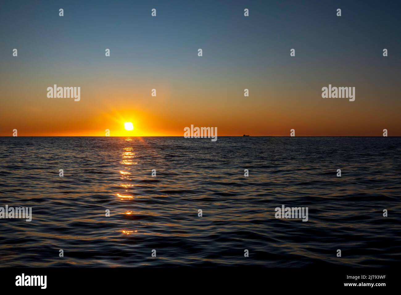 Amazing sunset on the Atlantic Ocean. The sun reflected in the waves ...