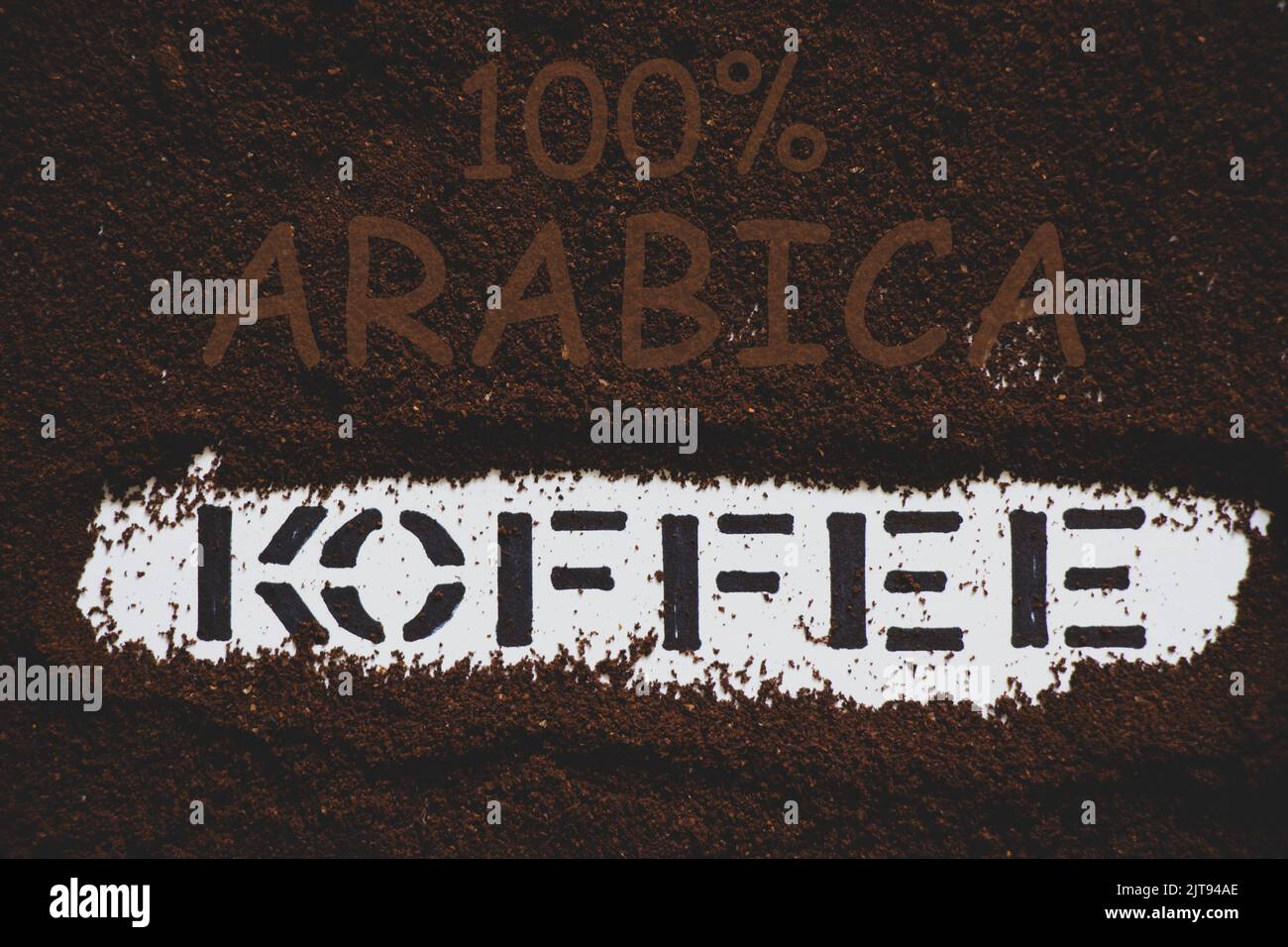 ground roasted coffee on white background and next to text coffee ...